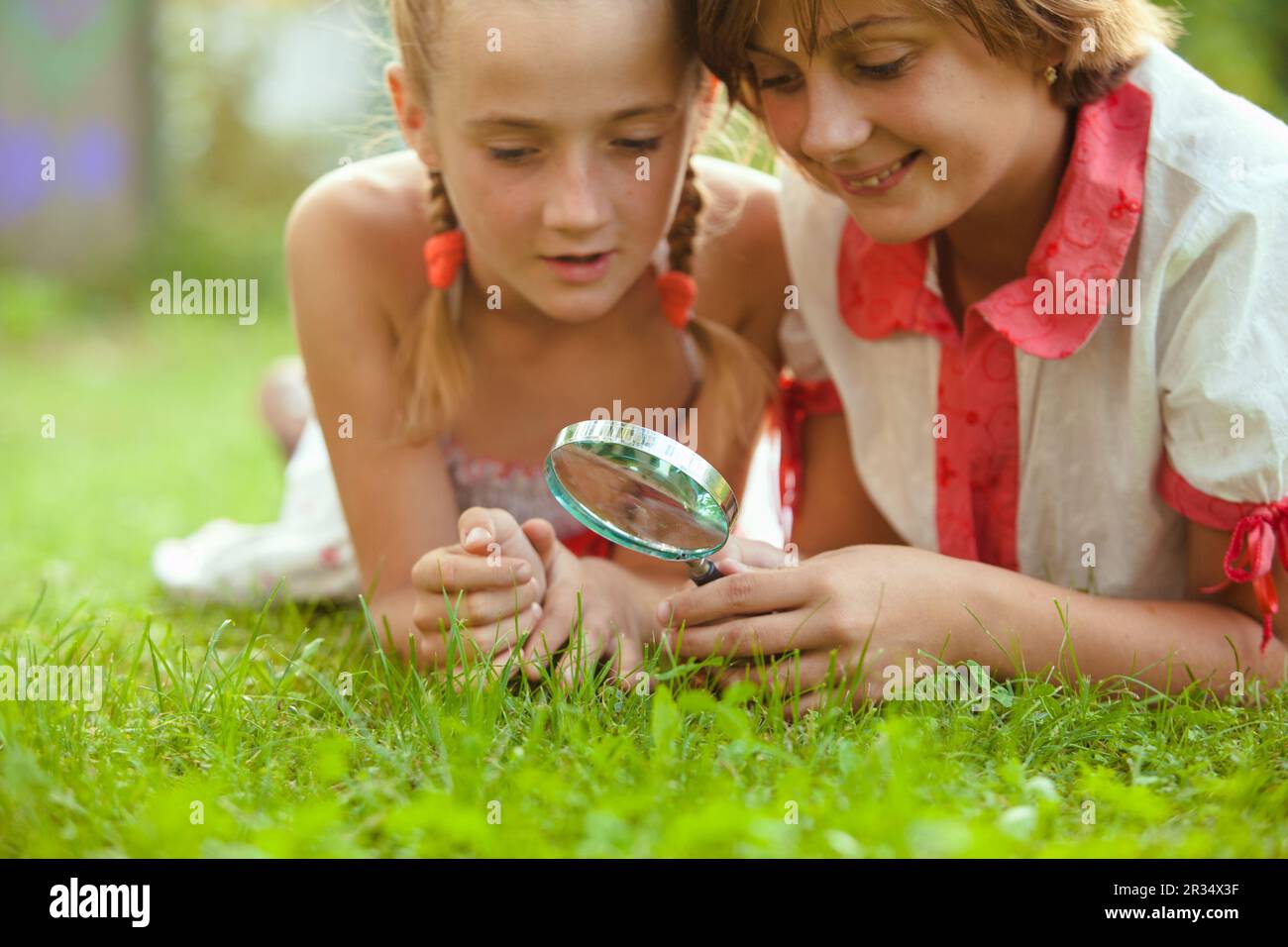 Kid with magnifying glass Stock Photo - Alamy