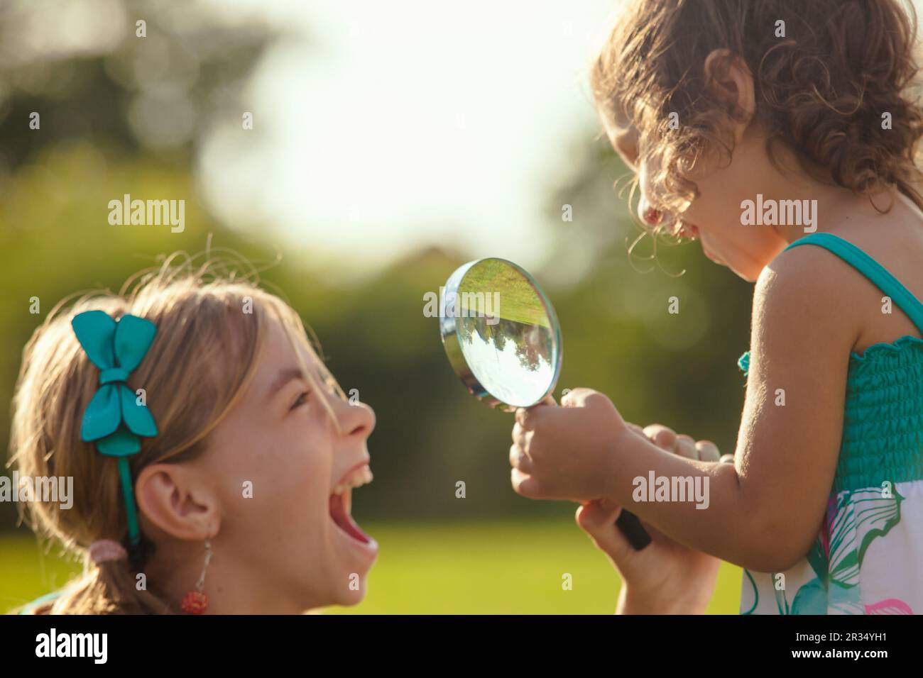 Kid with magnifying glass Stock Photo - Alamy
