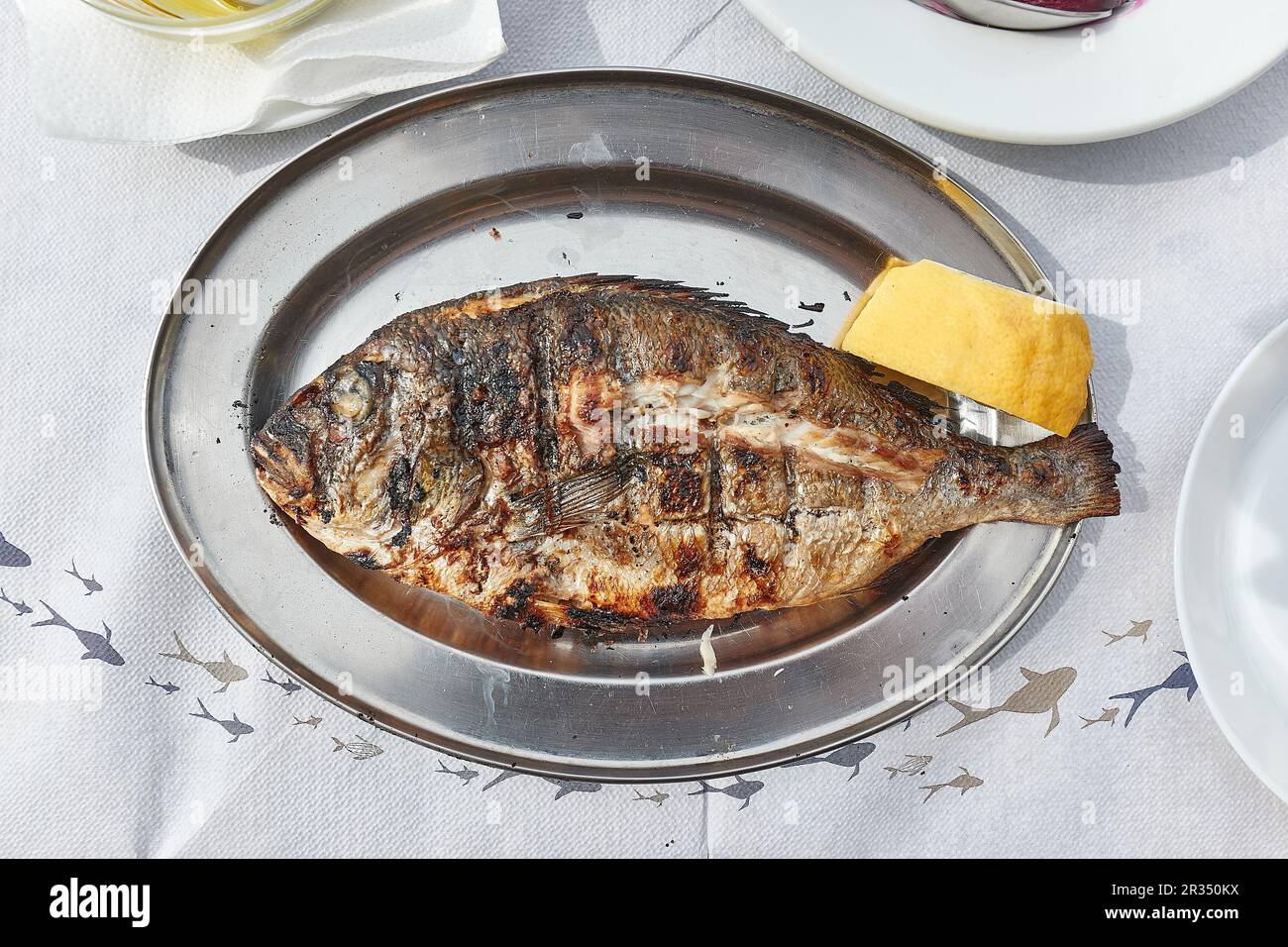 Eating fish plate for dinner Stock Photo - Alamy