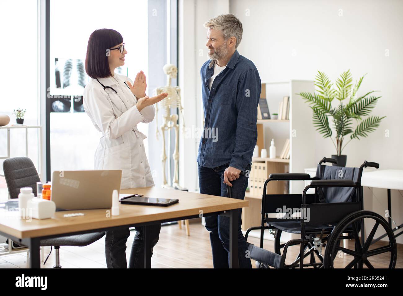 Smiling Female With Stethoscope Clapping While Happy Man Standing On