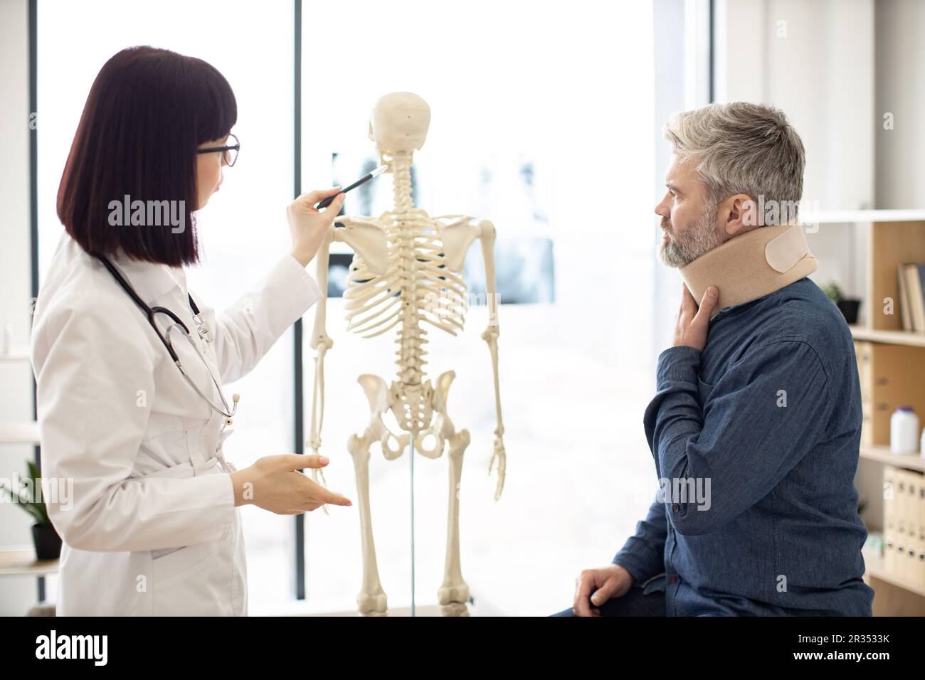 Side view of pretty lady in lab coat speaking to handsome man in ...