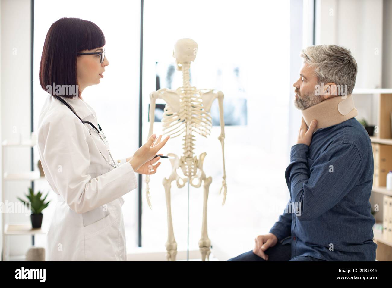 Side view of pretty lady in lab coat speaking to handsome man in ...