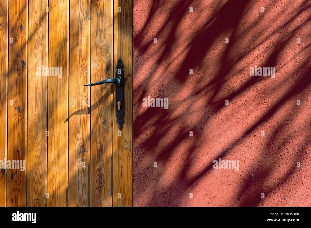 Wooden striped door with plain texture with grainy red wall texture ...