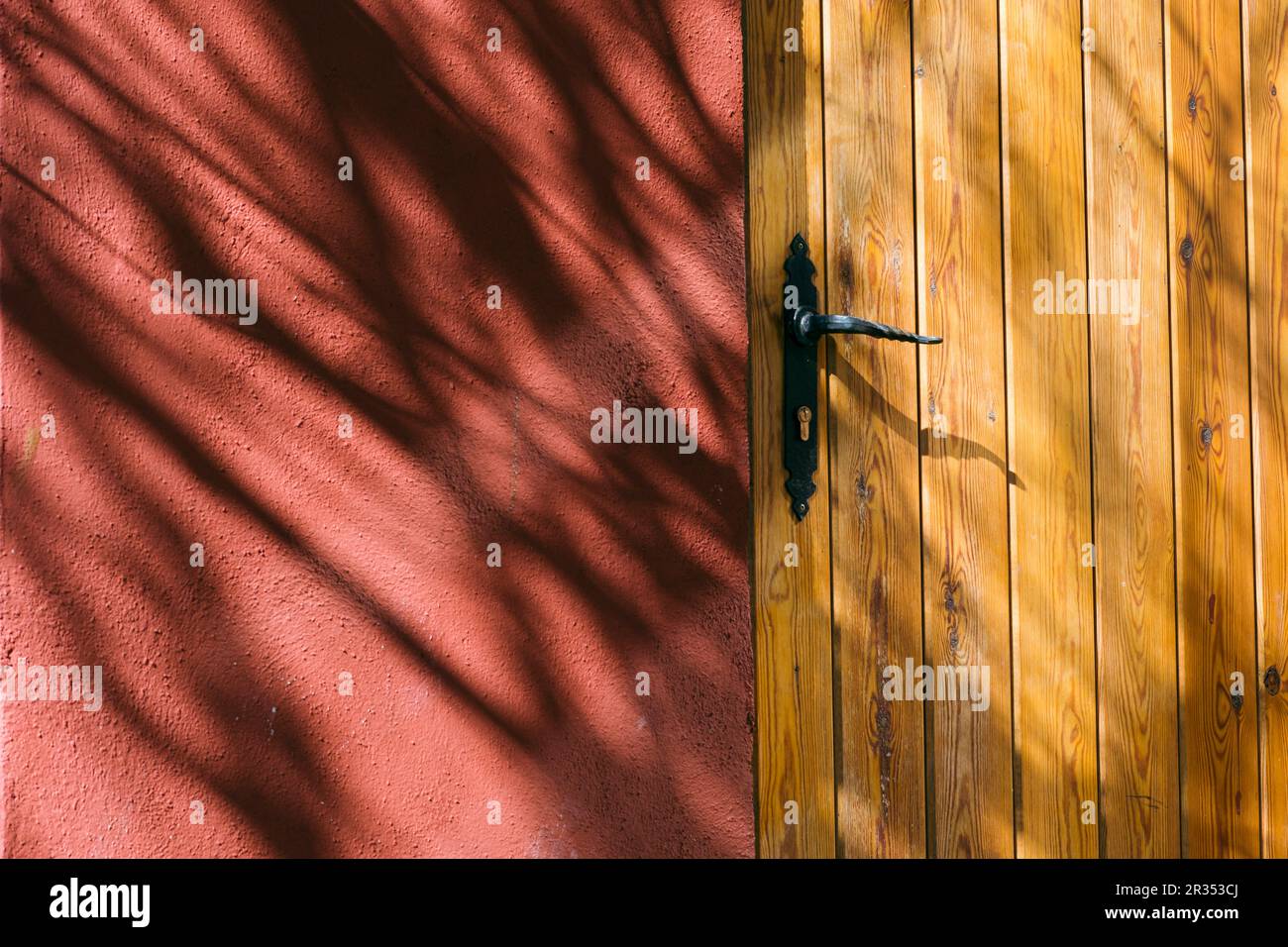 Wooden striped door with plain texture with grainy red wall texture ...