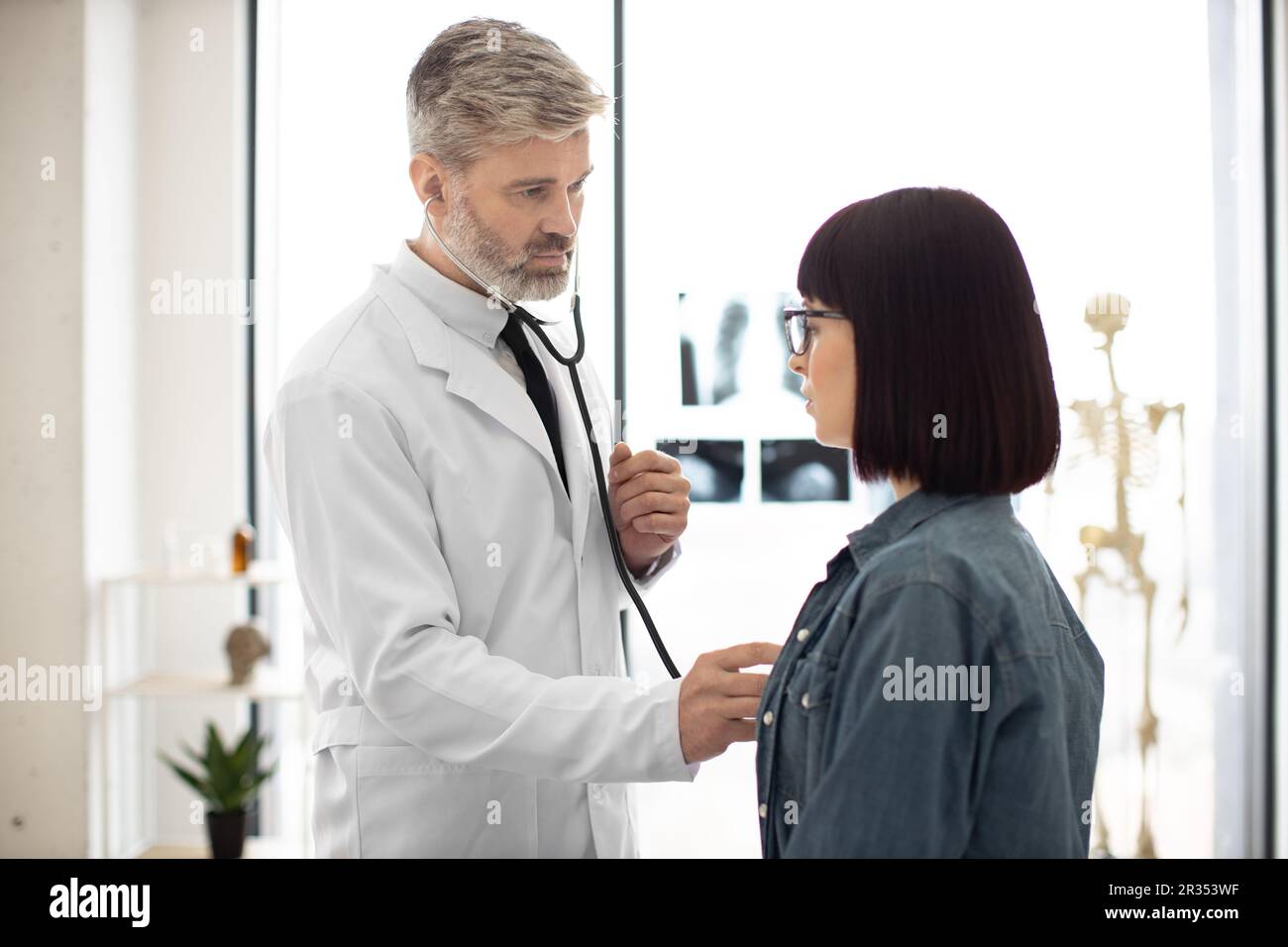 Therapist checking woman lungs stethoscope hi-res stock photography and ...