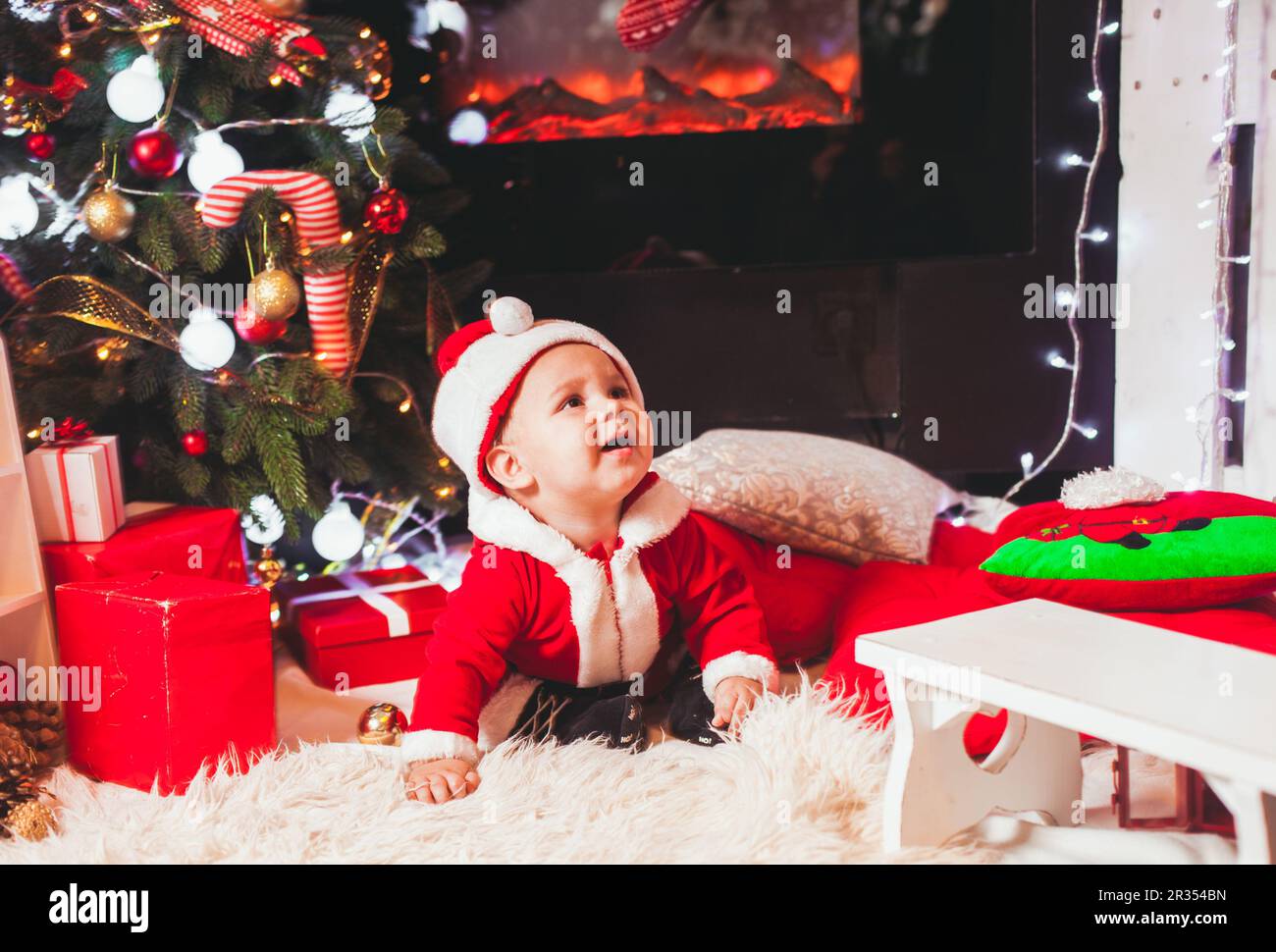 Baby in Santa costume Stock Photo - Alamy