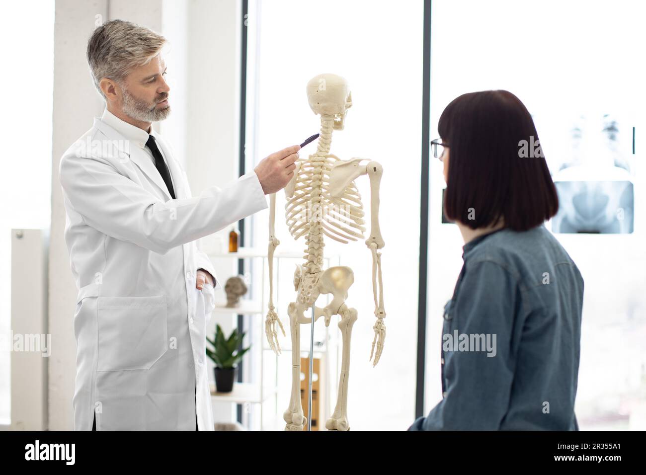 Close up of stylish male in lab coat showing neck bones to brunette ...