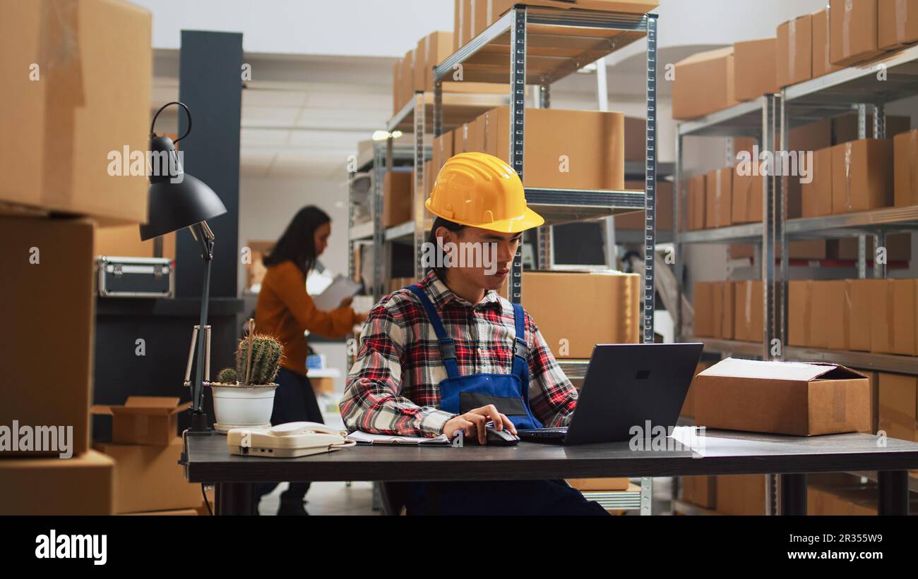 Asian person planning order management in warehouse Stock Photo - Alamy