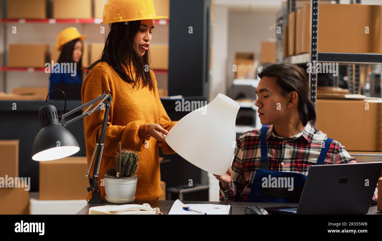 Man and woman organizing products on depot racks Stock Photo - Alamy