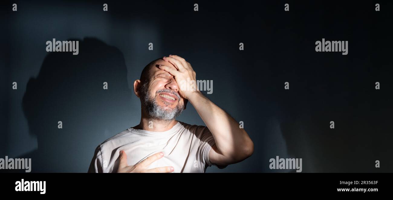 Sad man suffering from headache or migraine. Stressed guy with painful ...