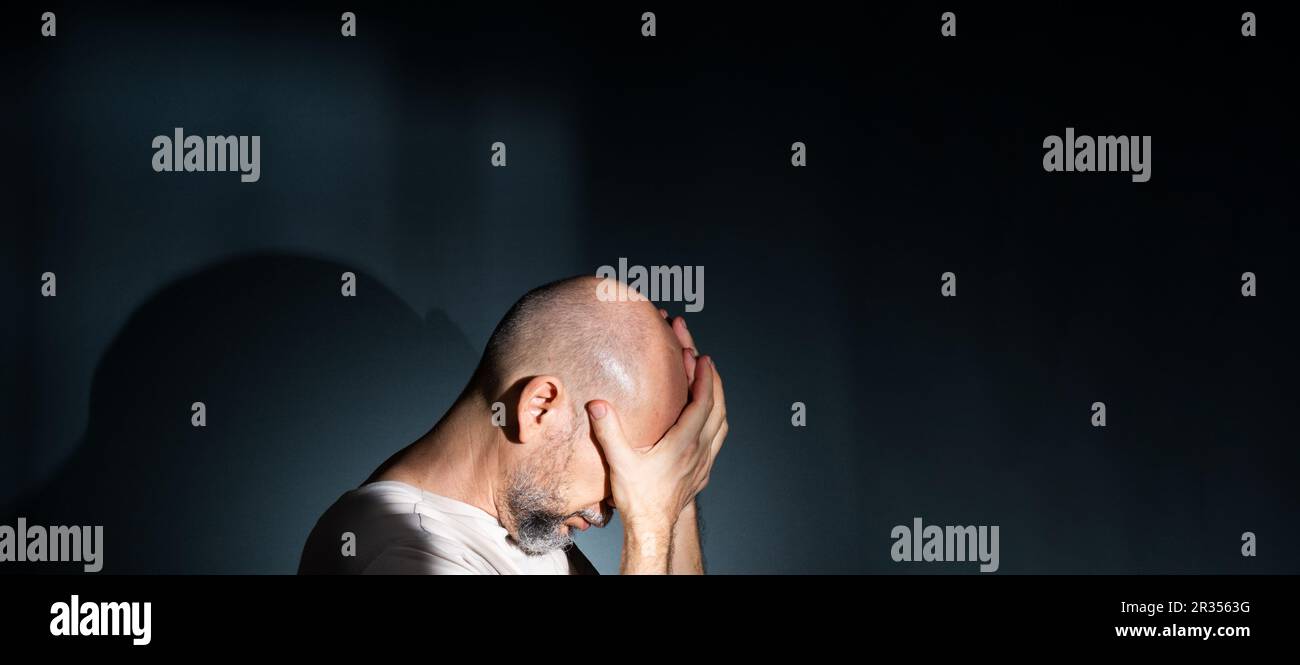 Sad man suffering from headache or migraine. Stressed guy with painful ...