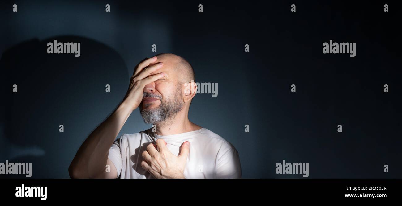 Sad man suffering from headache or migraine. Stressed guy with painful ...