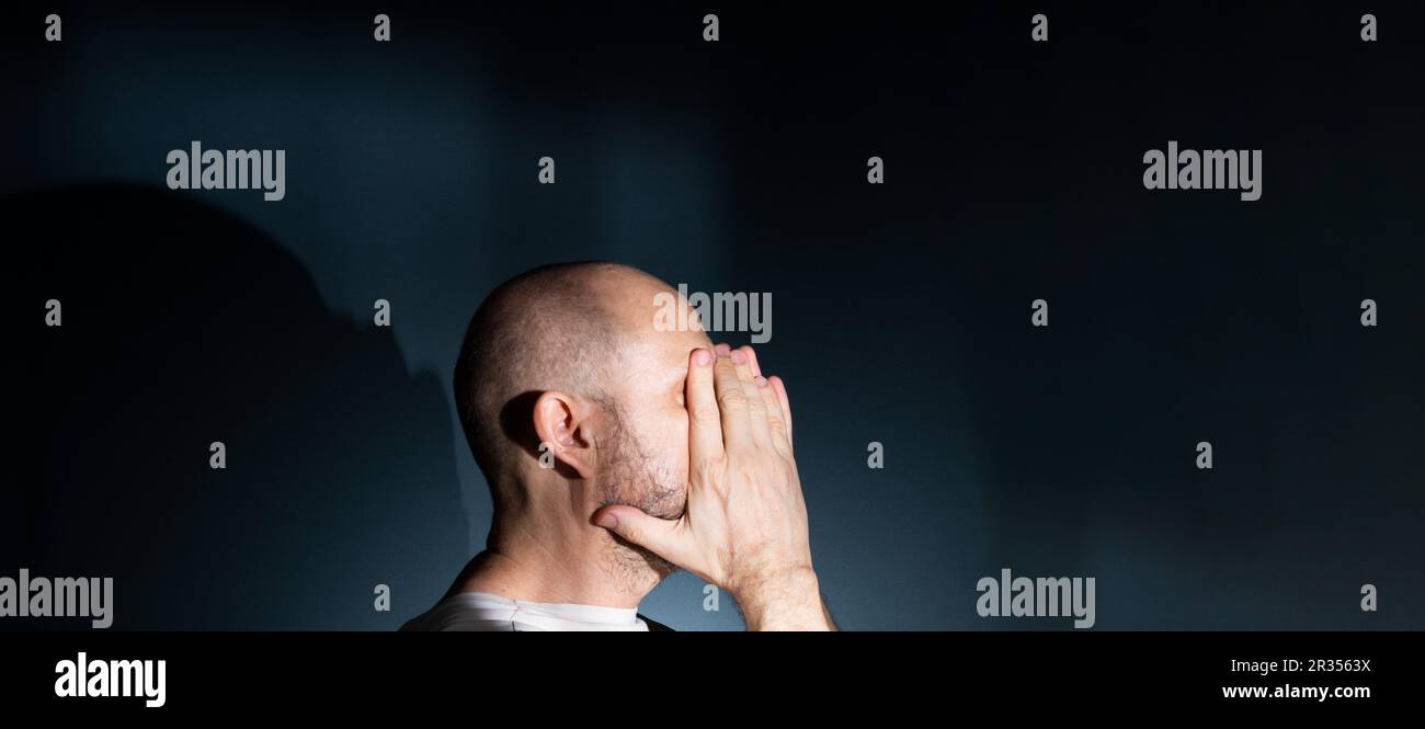 Sad man suffering from headache or migraine. Stressed guy with painful ...