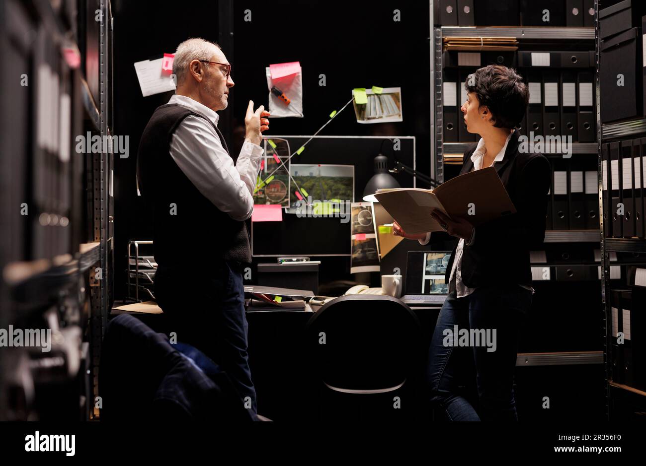 Police officers analyzing criminal investigations evidence Stock Photo ...