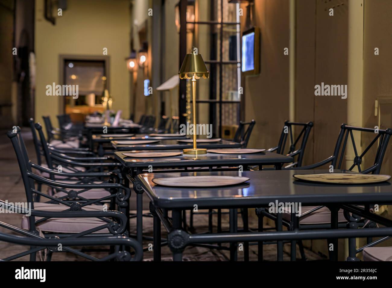 Empty outdoor tables waiting for customers at an Italian restaurant in ...