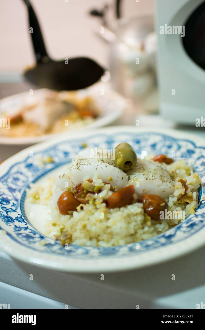 Dish with delicious rice with hake and cherry tomatoes. Kitchen Stock ...