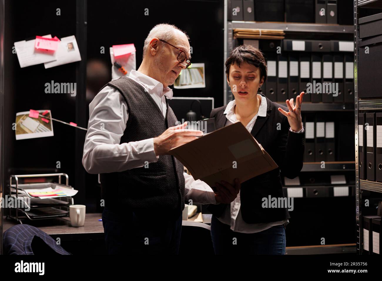 Police officers analyzing scene crime evidence files Stock Photo - Alamy
