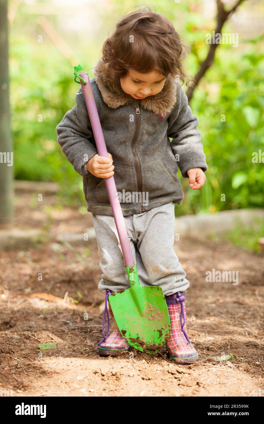 The little girl with a small shovel Stock Photo - Alamy