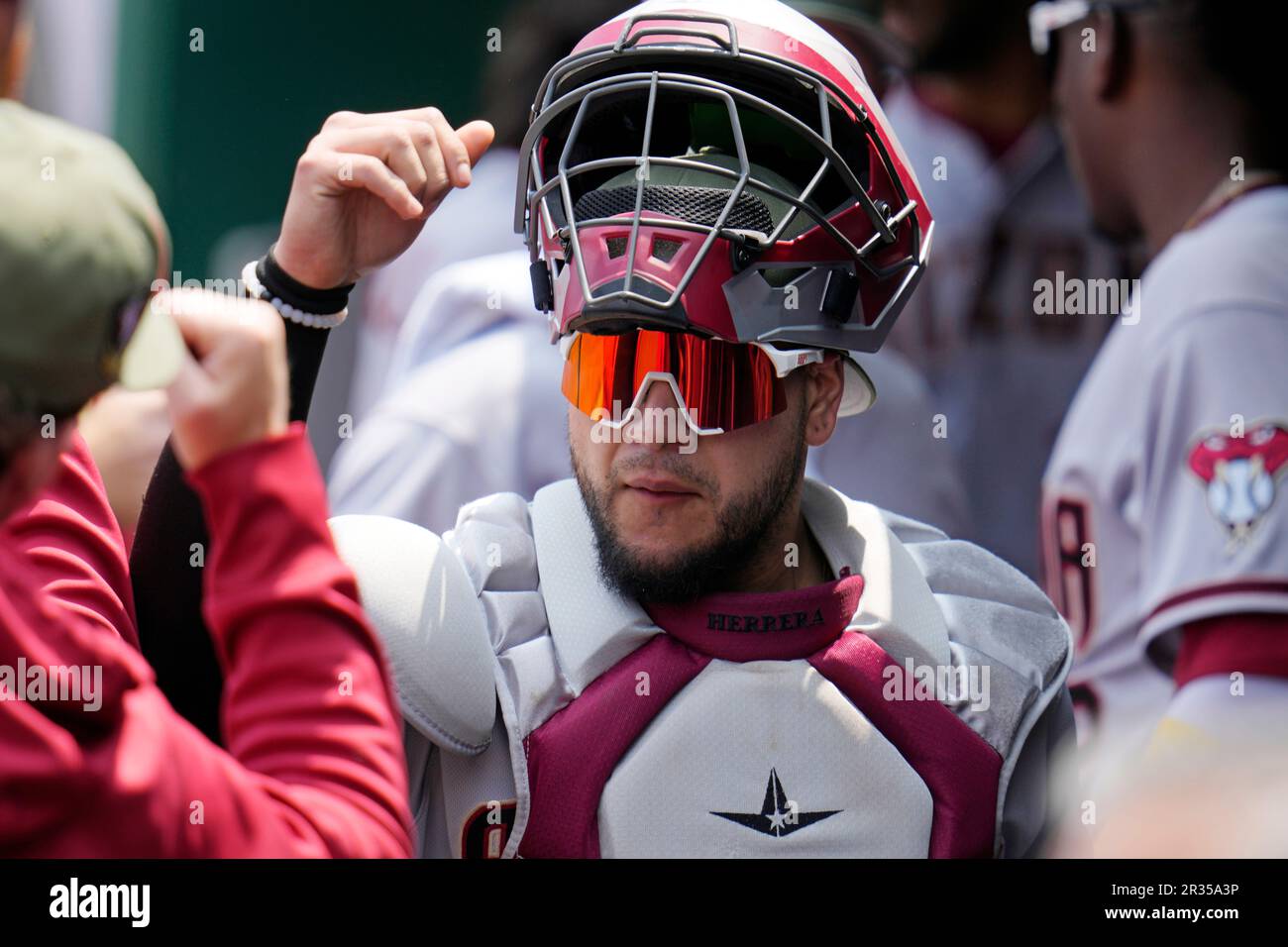 Arizona Diamondbacks catcher Jose Herrera, center, walks in the dugout ...