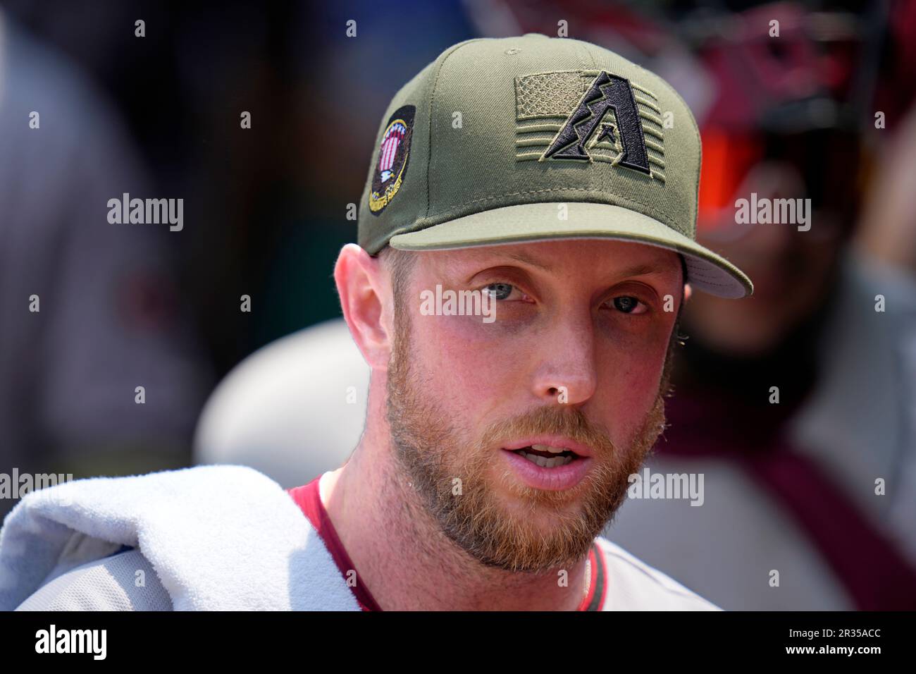 Arizona Diamondbacks starting pitcher Merrill Kelly walks in the dugout ...