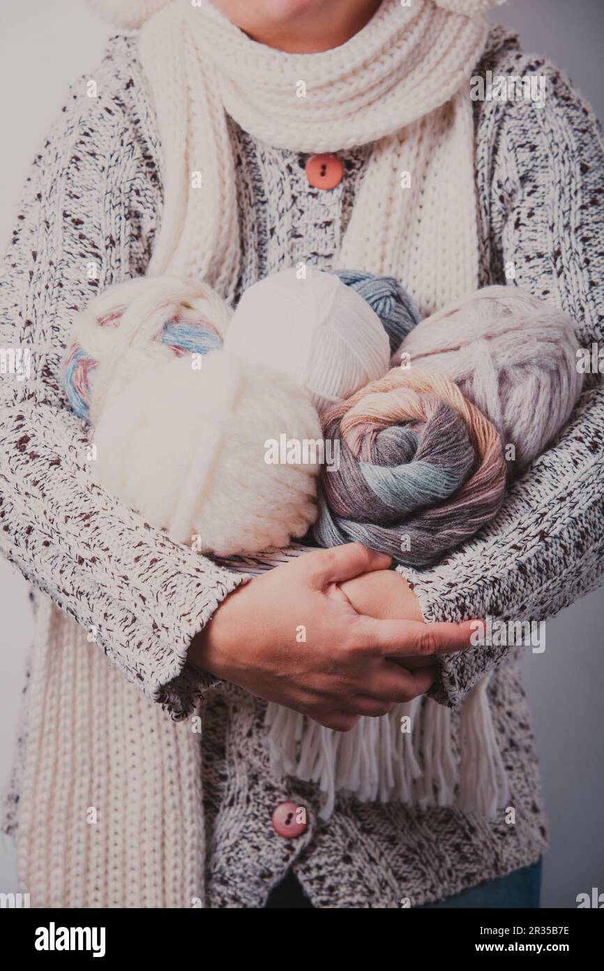 Woman with basket of balls woolen yarn Stock Photo - Alamy