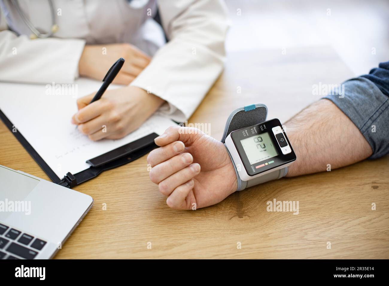 Crop of male patient measuring blood pressure with modern electronic ...