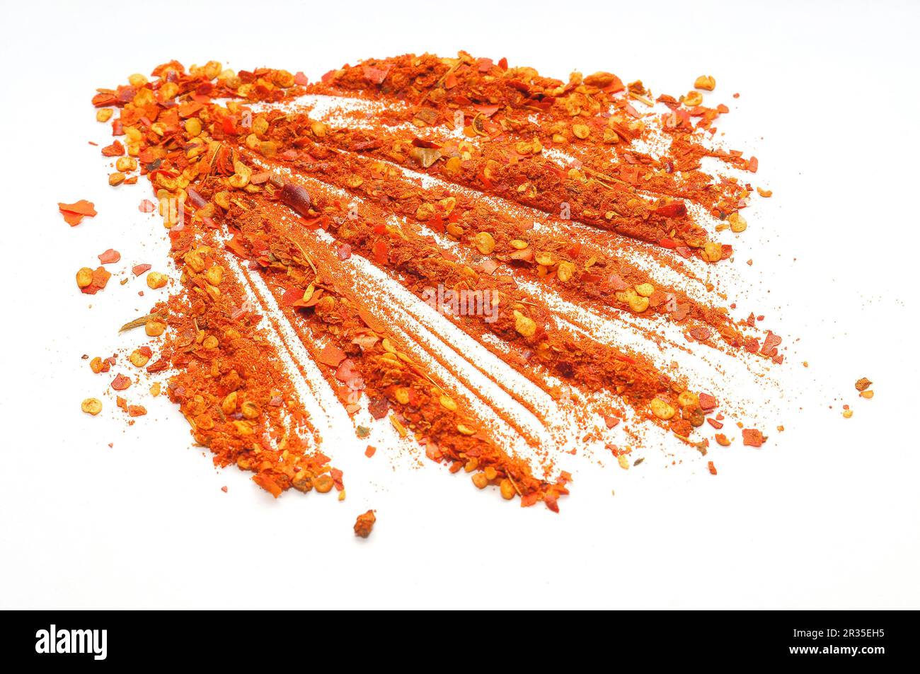 Red hot chili ground pepper scattered on a white background Stock Photo ...