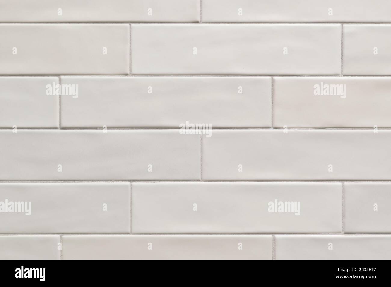White smooth long thin horizontal tile pattern on a wall, background ...