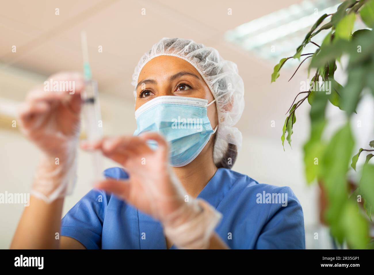Confident woman doctor holding syringe for injection Stock Photo - Alamy