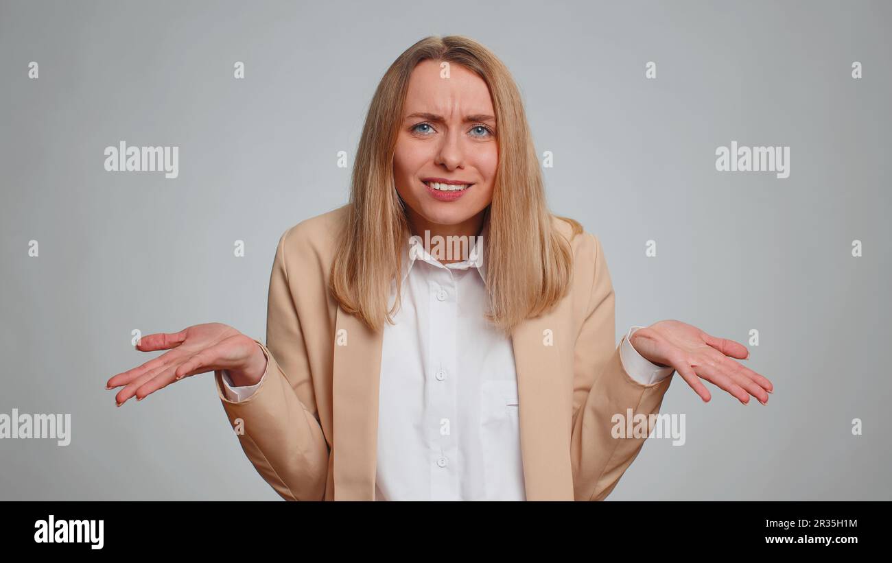 What Why. Sincere irritated business woman raising hands in indignant ...