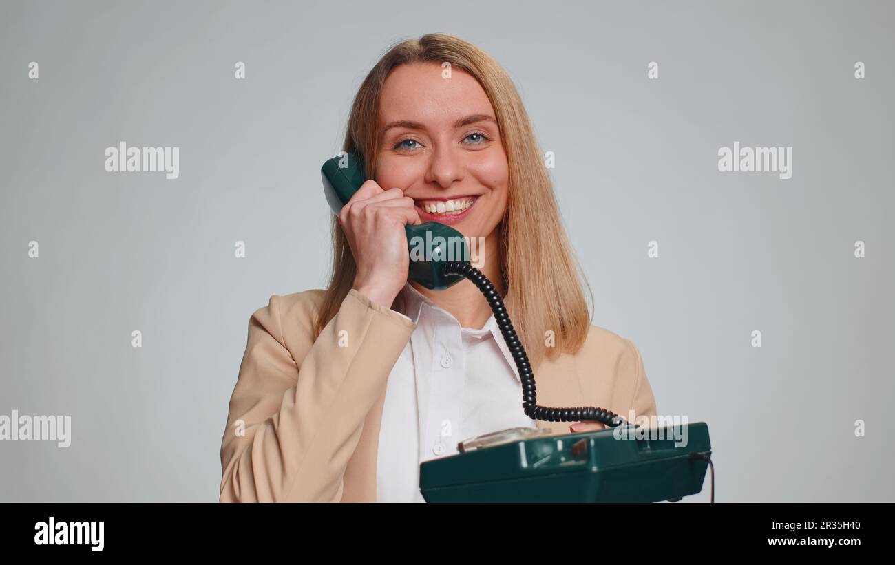 Hey you, call me back. Business woman talking on wired vintage ...