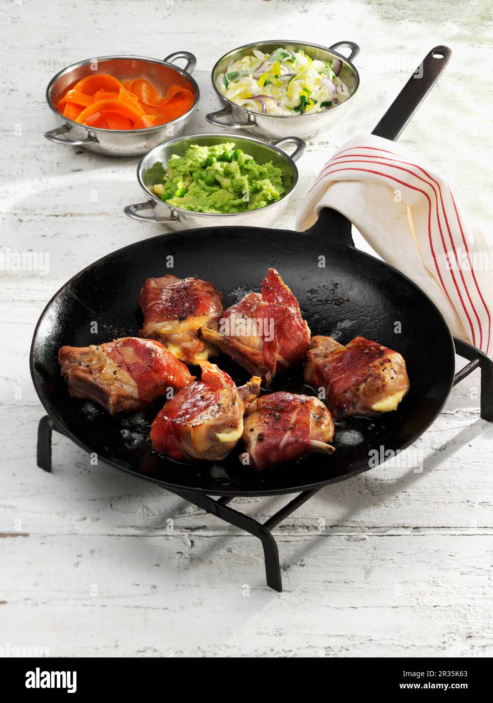 Suckling pig chops wrapped in ham with a cheese filling Stock Photo - Alamy