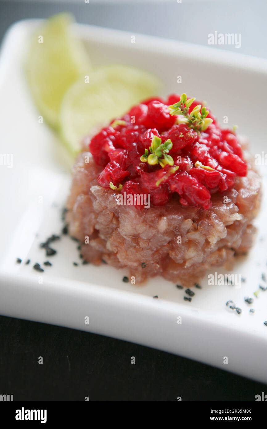 Tuna fish tatar with red fruit salsa Stock Photo - Alamy