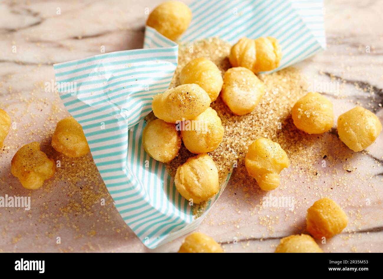 Deep-fried puff pastry balls with tonka bean vanilla sugar Stock Photo ...
