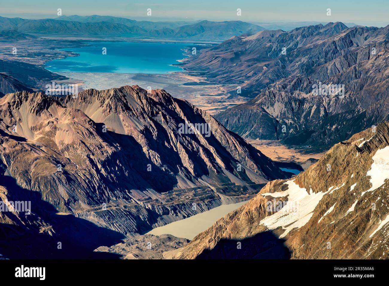 Flying over the Southern alps and its peaks and alpine lakes. Lake ...