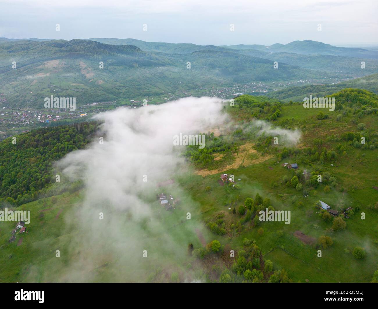 An aerial view of a green valley of Yaremche with a cloud cover, trees ...