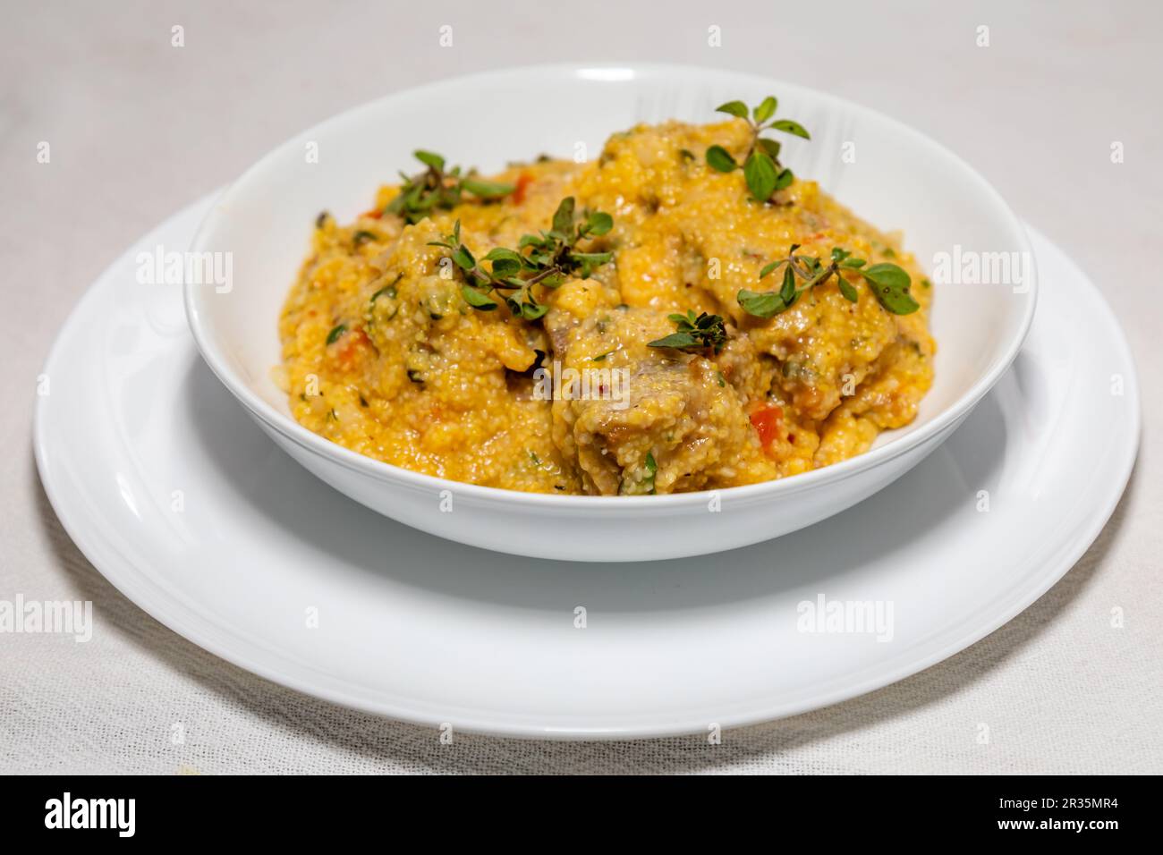 Traditional pork tenderloin recipe with corn grits and fresh marjoram ...