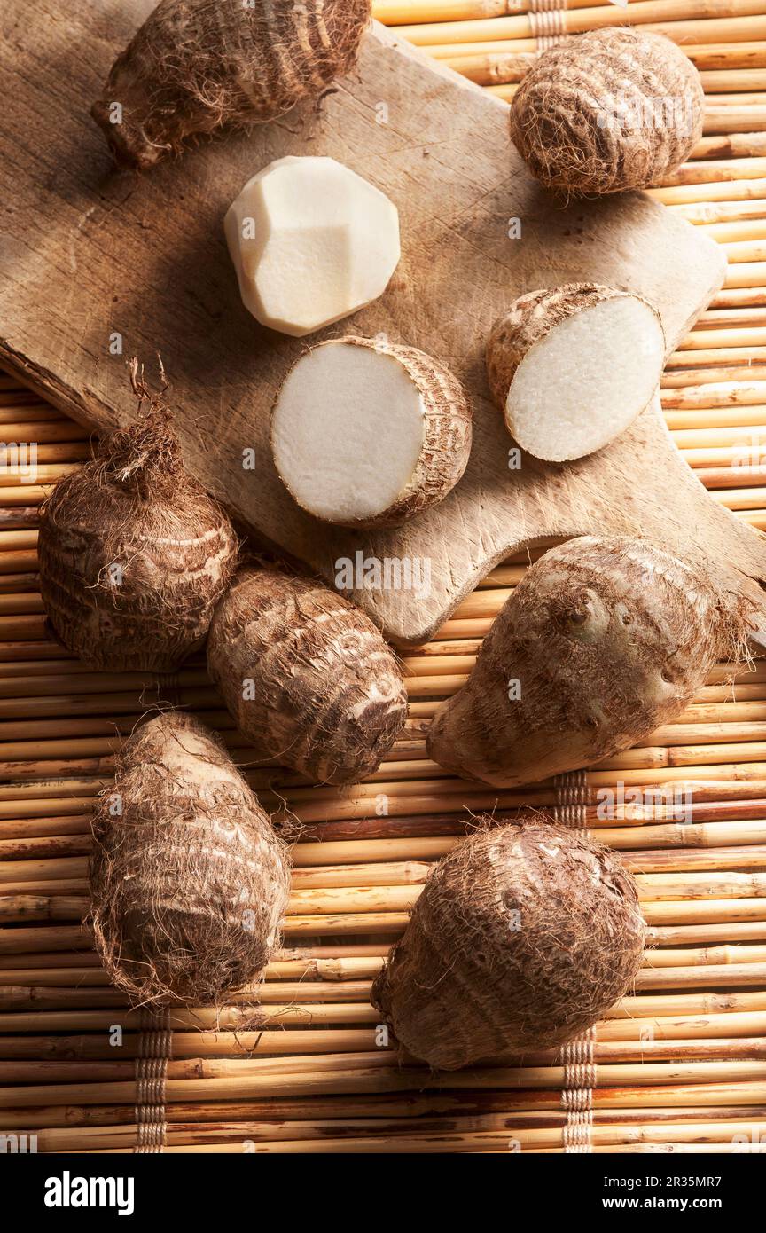 Taro roots, whole and halved Stock Photo - Alamy