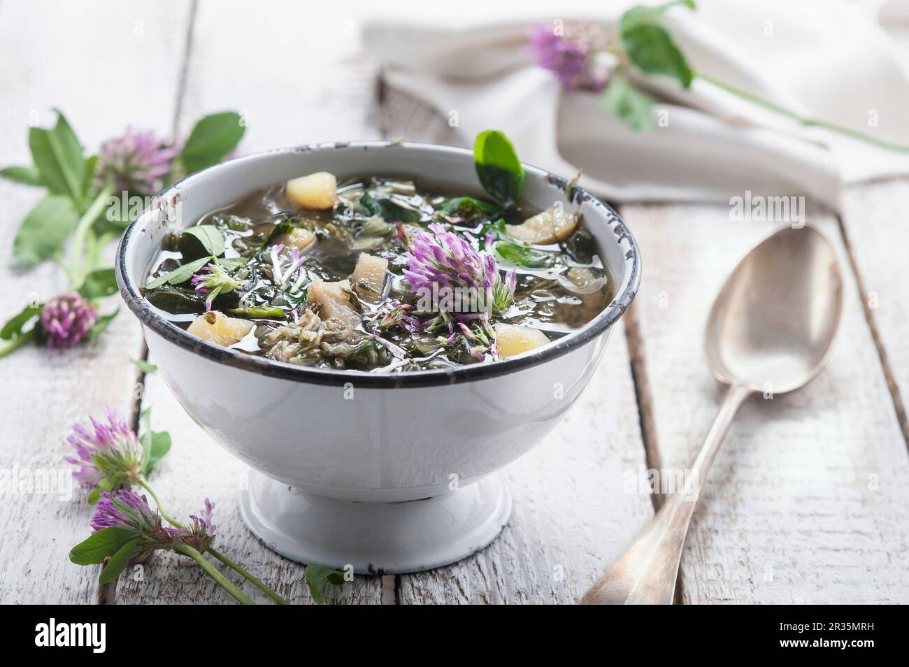 Vegetable soup with clover flowers Stock Photo - Alamy