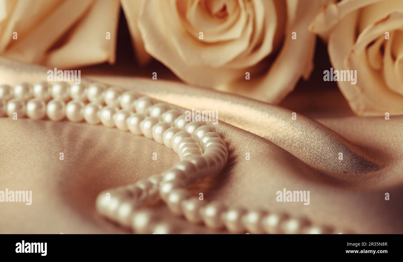 Pearl beads and cream rose Stock Photo - Alamy