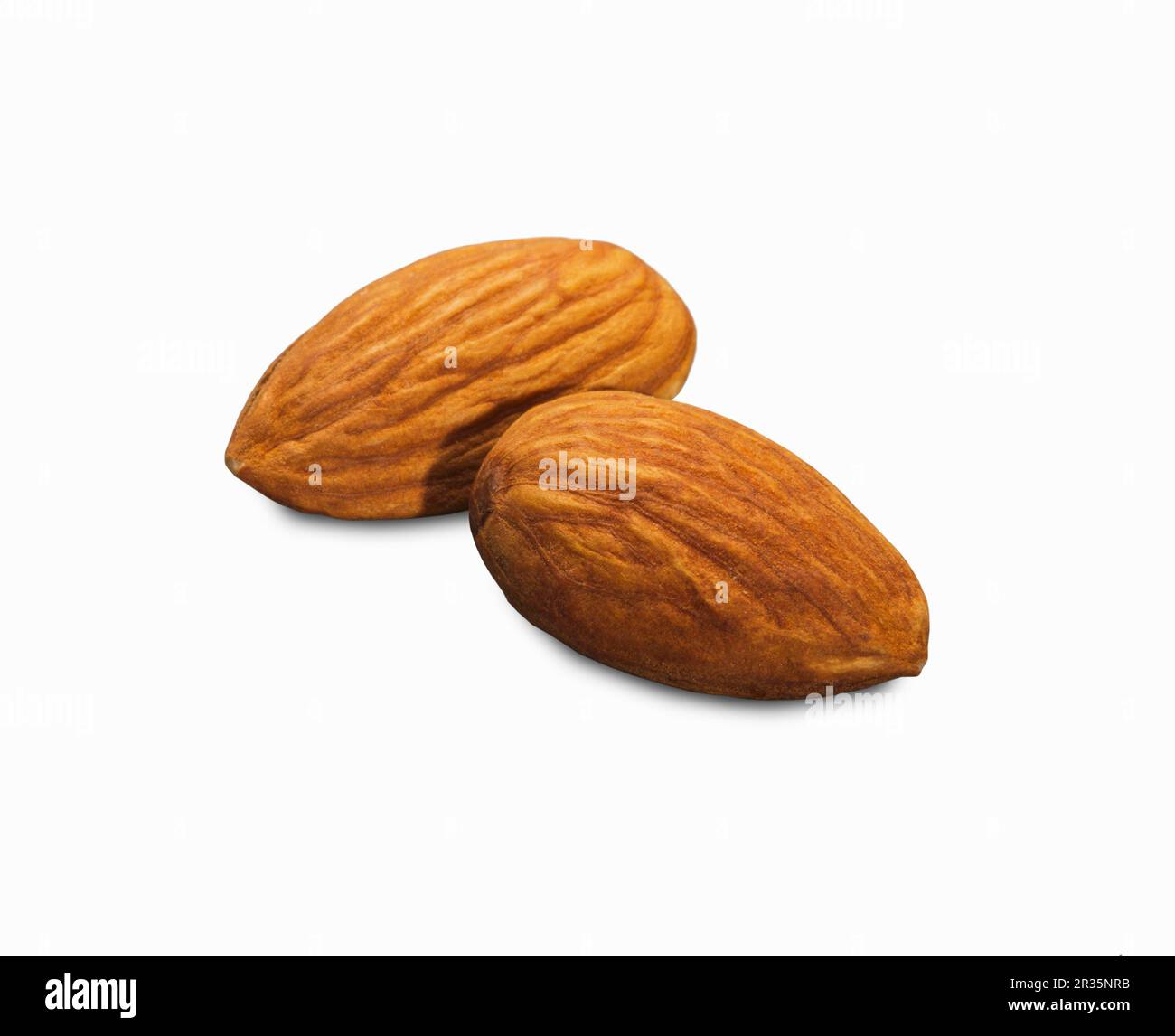 Two shelled almonds on a white surface (close-up Stock Photo - Alamy
