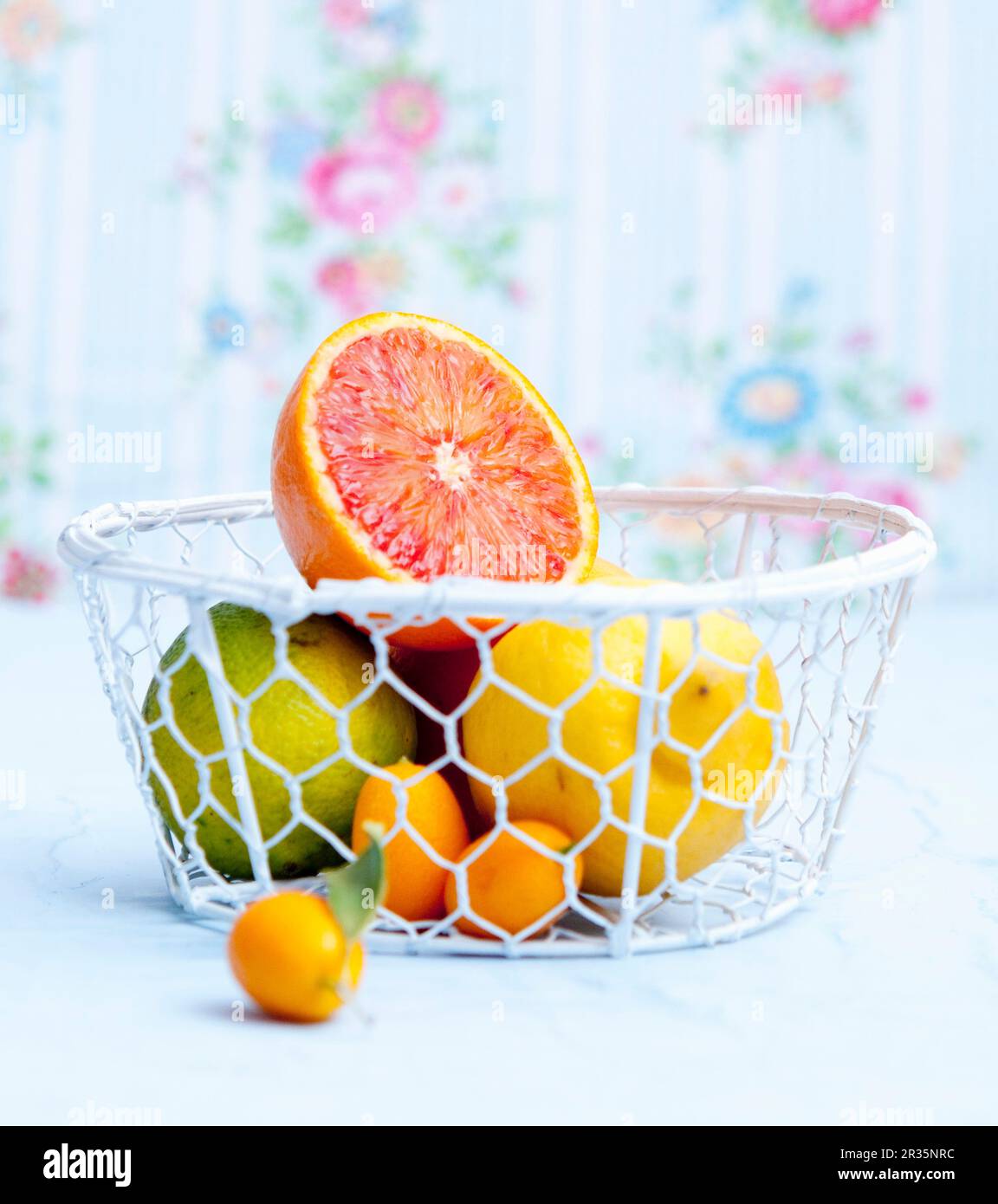 Various citrus fruit in a wire basket Stock Photo - Alamy