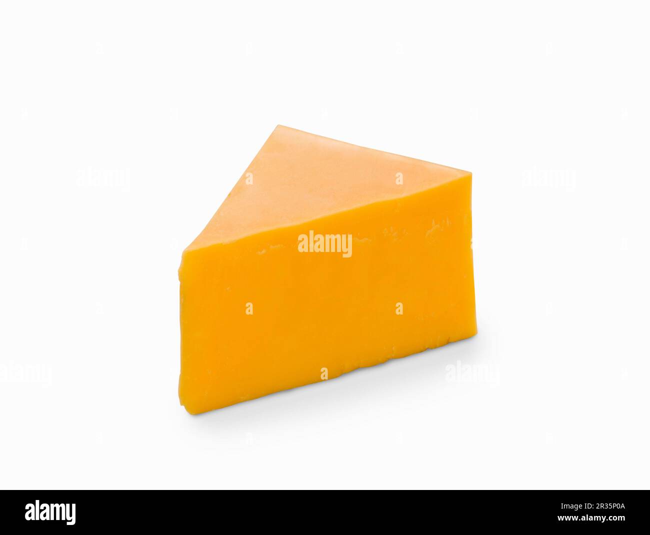 A slice of cheddar cheese on a white surface Stock Photo - Alamy