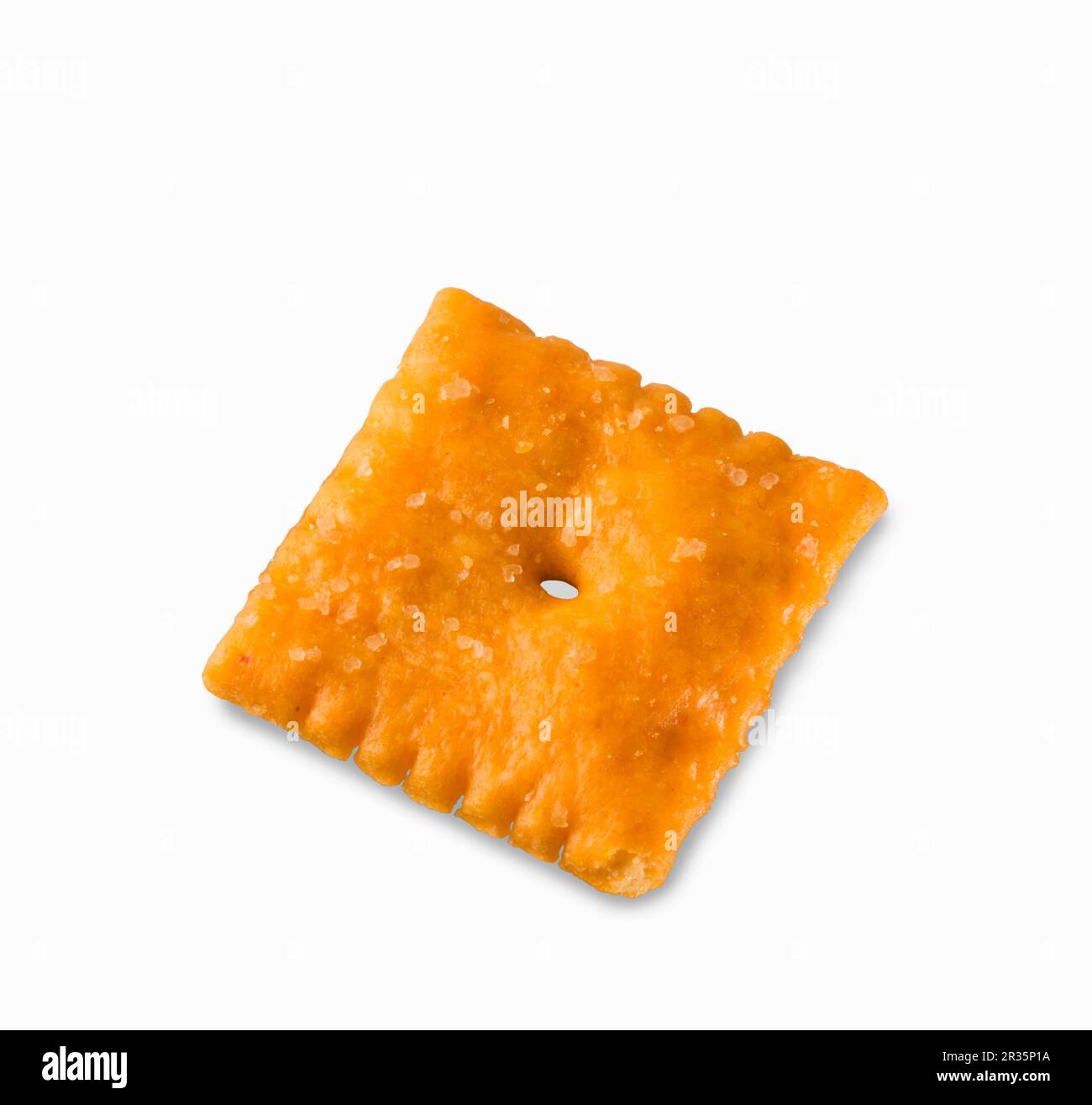 A cheddar cracker on a white surface (close-up Stock Photo - Alamy