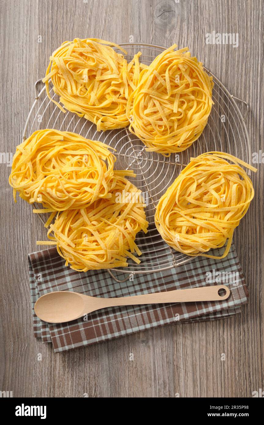 Five tagliatelle pasta nests hi-res stock photography and images - Alamy