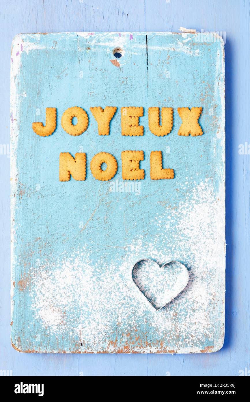 Christmas greetings written in French with biscuits and a cutter Stock ...