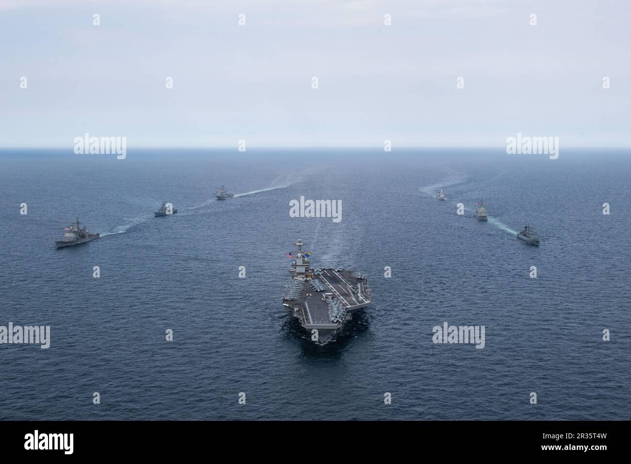 The Gerald R. Ford Carrier Strike Group sails in formation during a ...