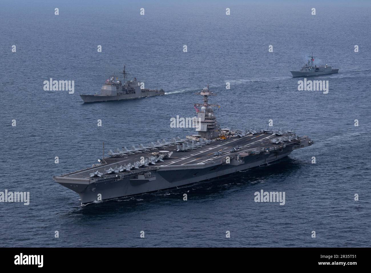 The Gerald R. Ford Carrier Strike Group sails in formation during a ...