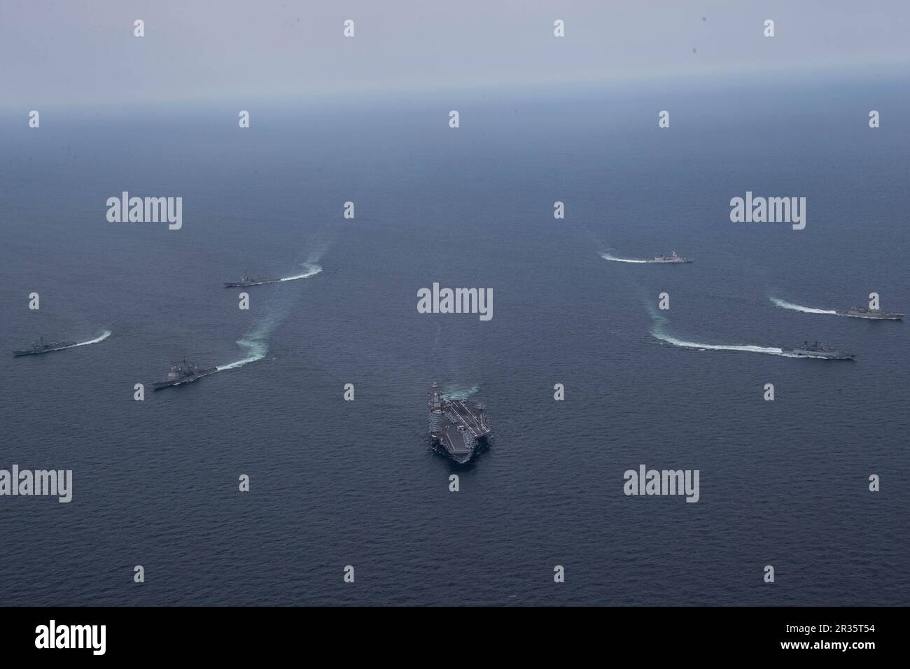 The Gerald R. Ford Carrier Strike Group sails in formation during a ...