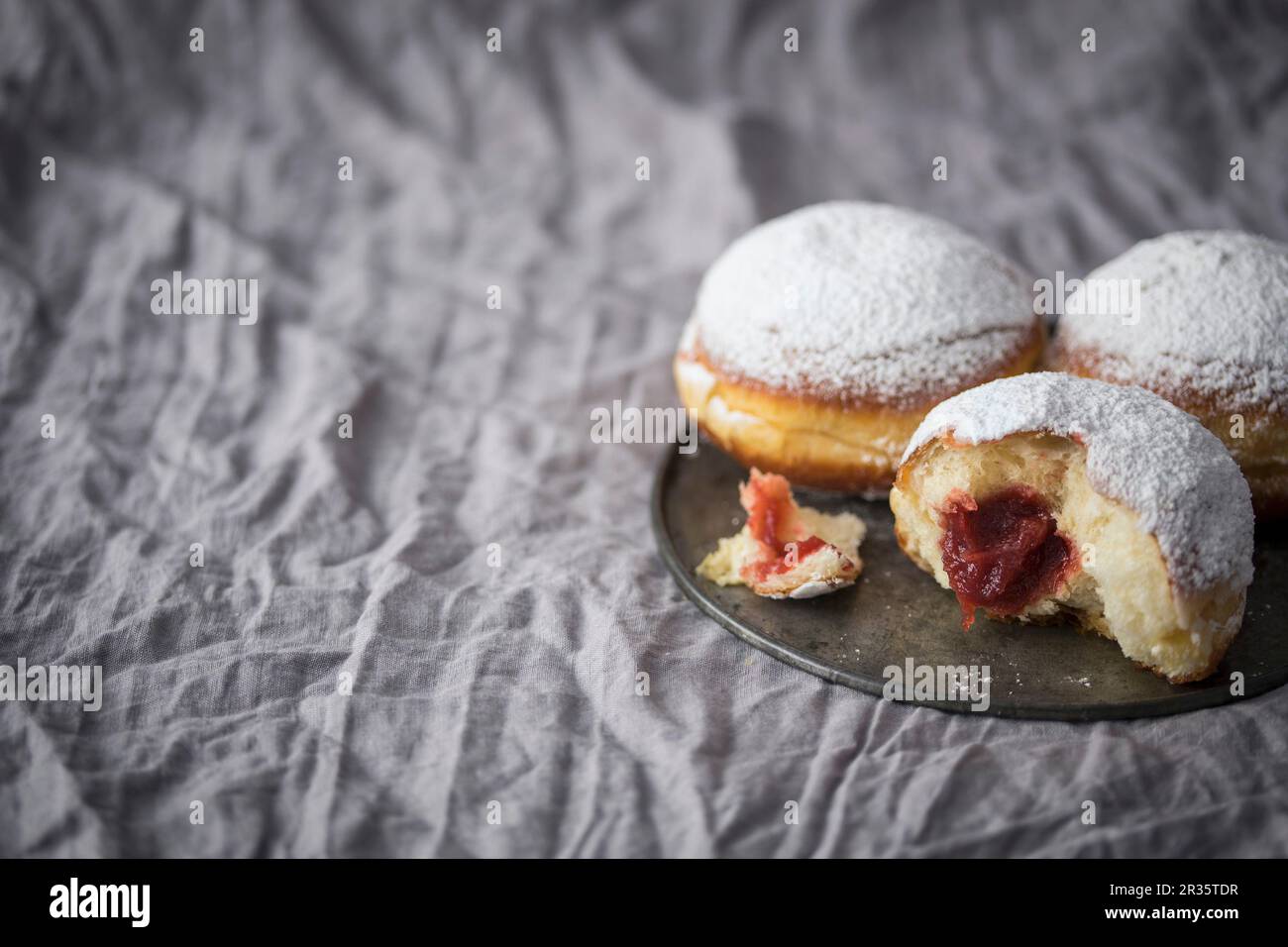 Traditional Polish donuts filled with marmalade and dusted with icing ...